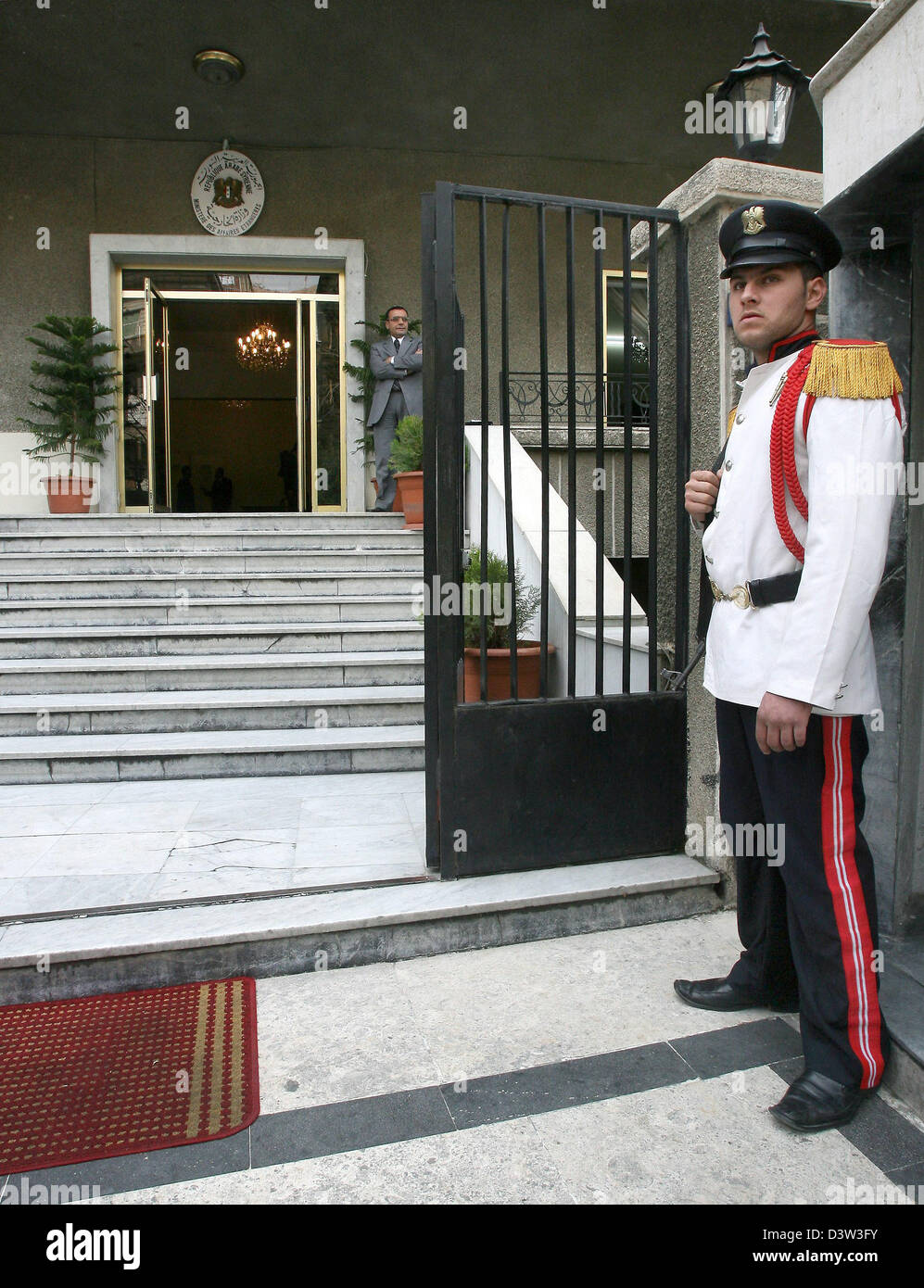 A watchman guards the entrance to the Syrian Foreign Ministry in ...