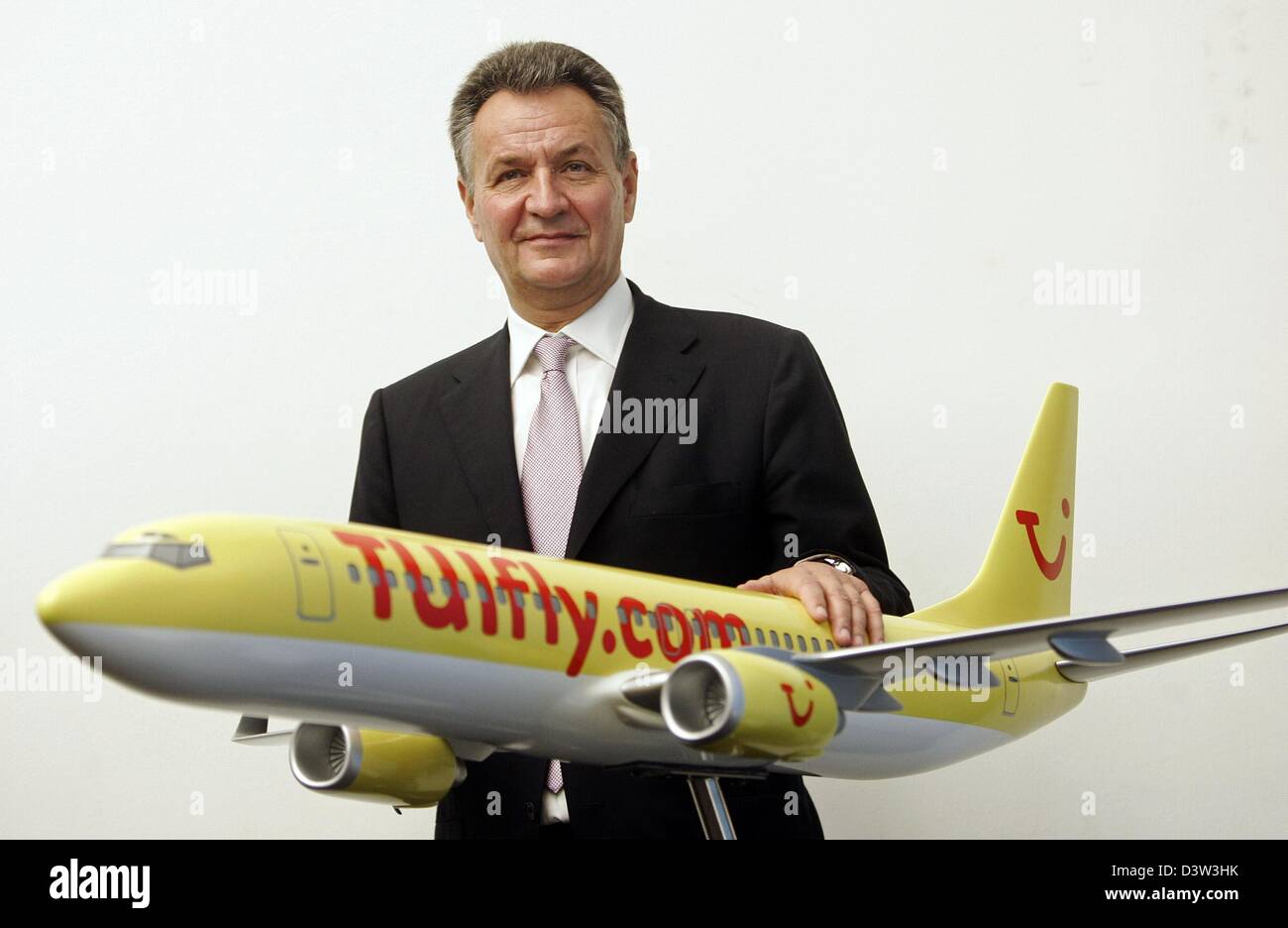 CEO of TUI Michael Frenzel poses with a model of an airplane at a press ...