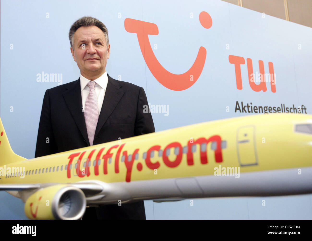 CEO of TUI Michael Frenzel poses with a model of an airplane at a press ...