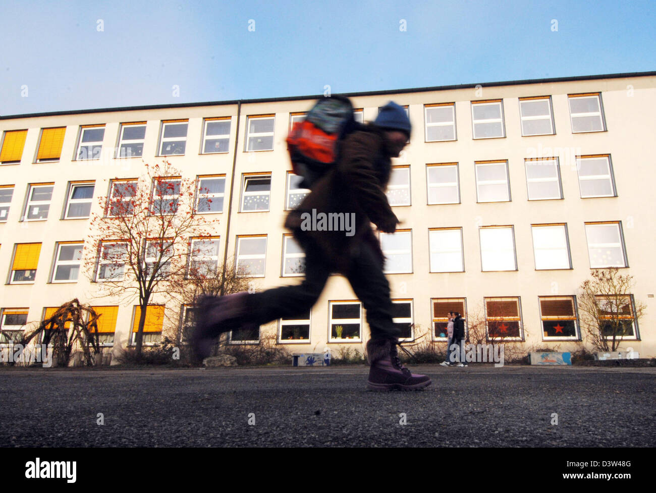 A Pupil of a 'Hauptschule' (basic secondary school) runs across the ...