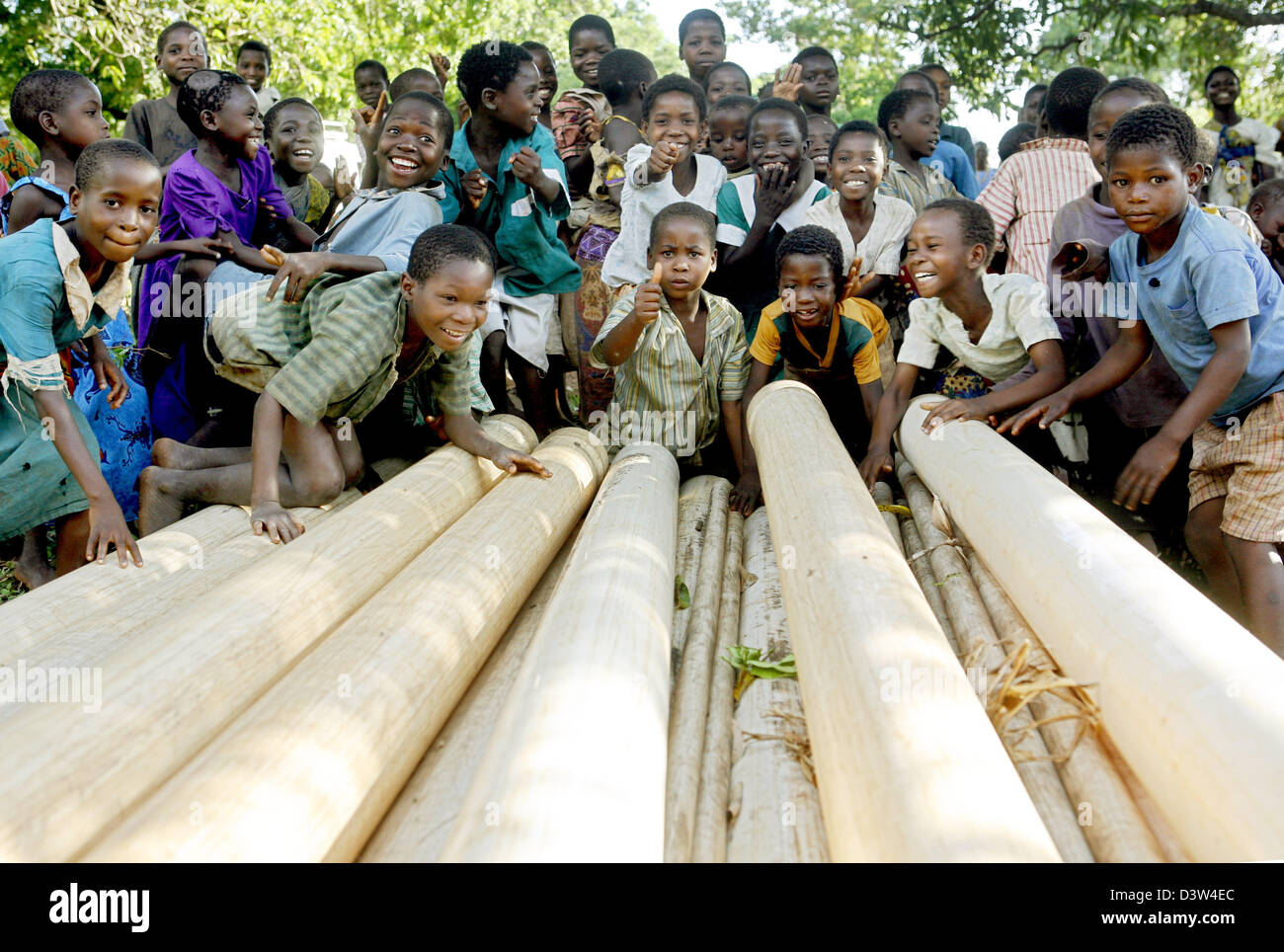 Children climb over pipes for an irrigation plant in the town Chitimbre ...
