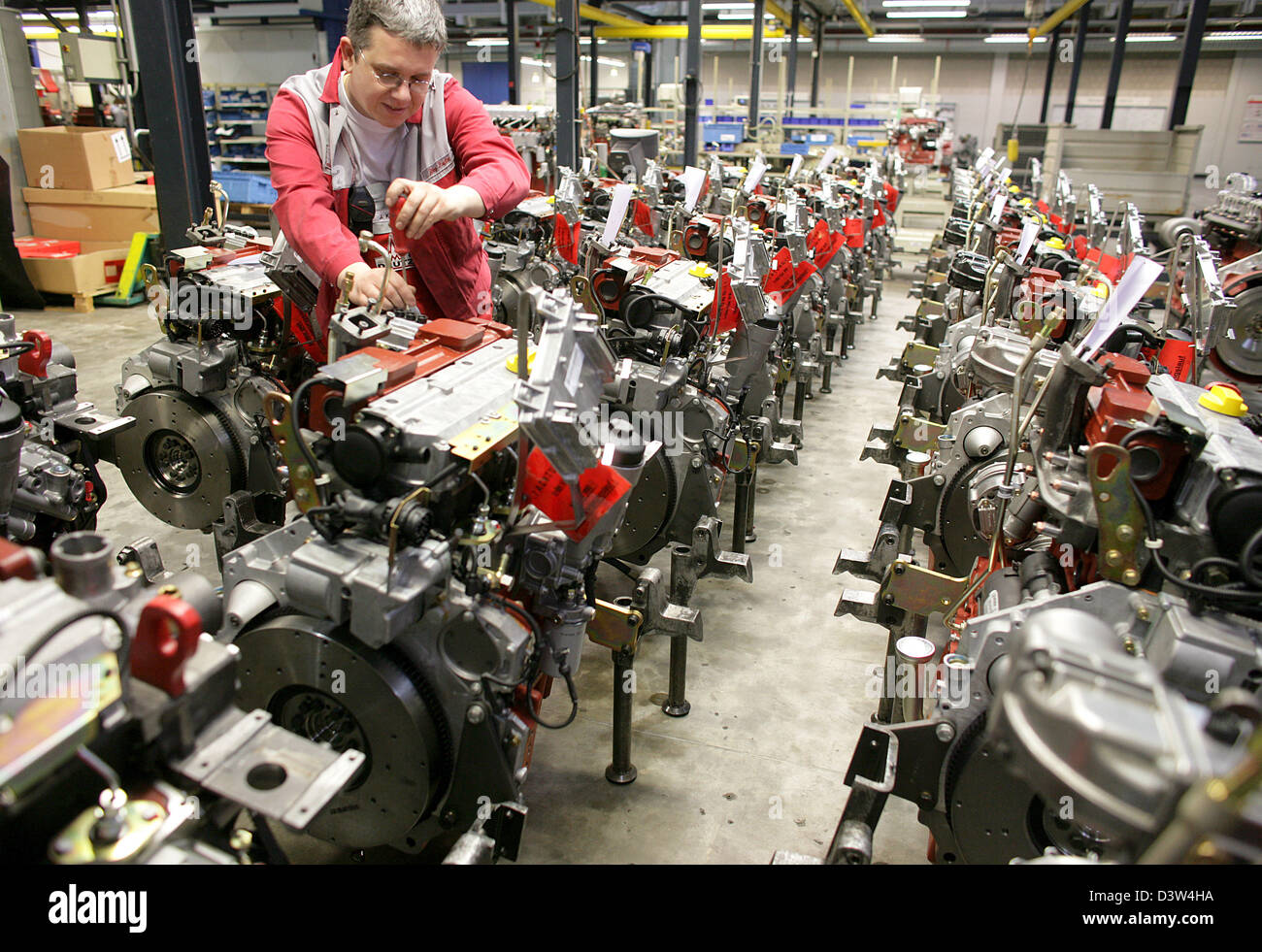 An employee of 'Deutz AG' screws at an engine in the facility Eli in ...