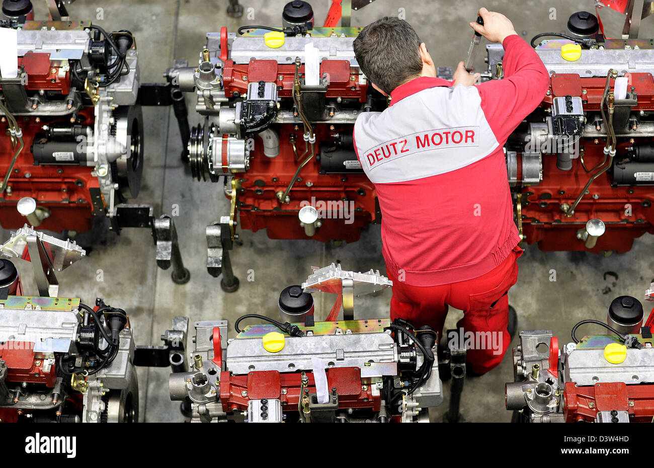 An employee of 'Deutz AG' screws at an engine in the facility Eli in ...