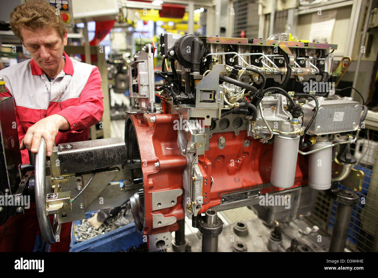 An employee of 'Deutz AG' screws at an engine in the facility Eli in ...