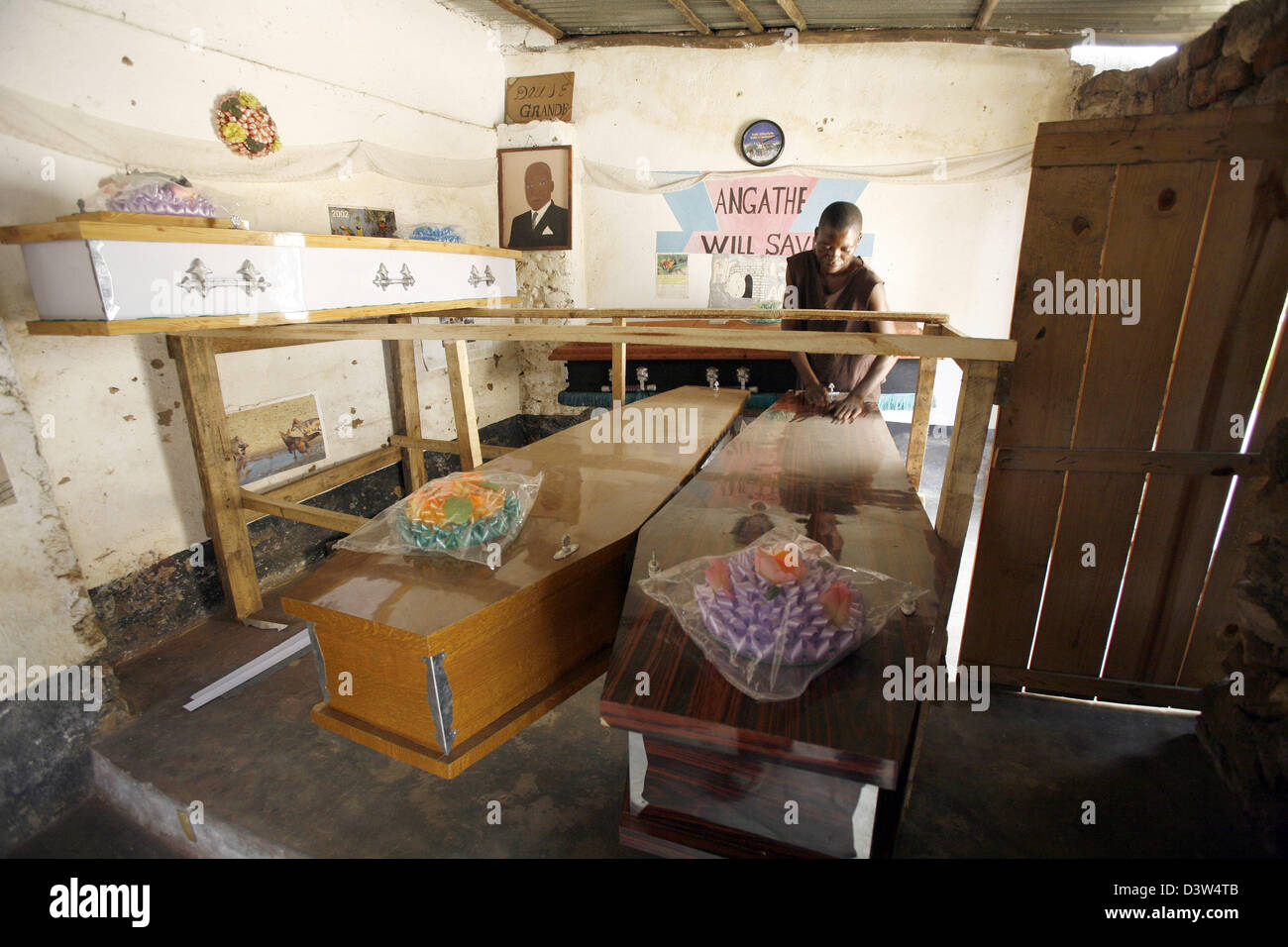 The picture shows coffins displayed in a humble workshop of a ...