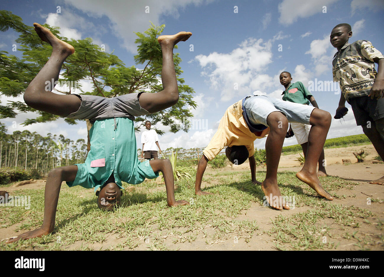 Two boys perform acrobatic feats in the village of Njale, Province ...