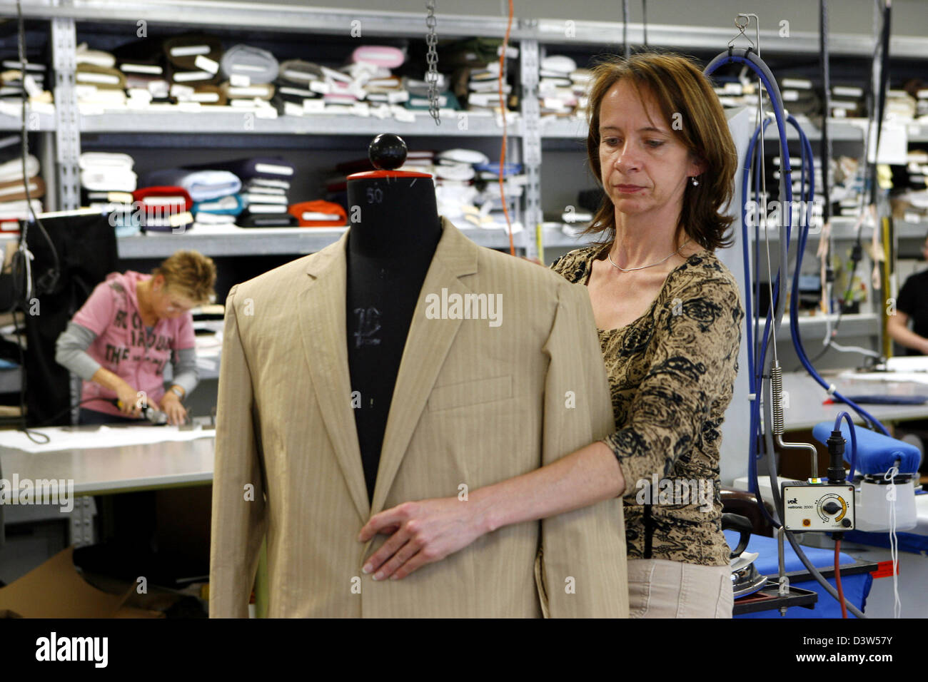 An employee works on a model jacket in fashion and lifestyle company s ...