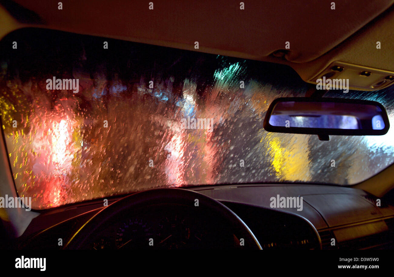 The photo shows the view through the windscreen of a car in a car wash ...