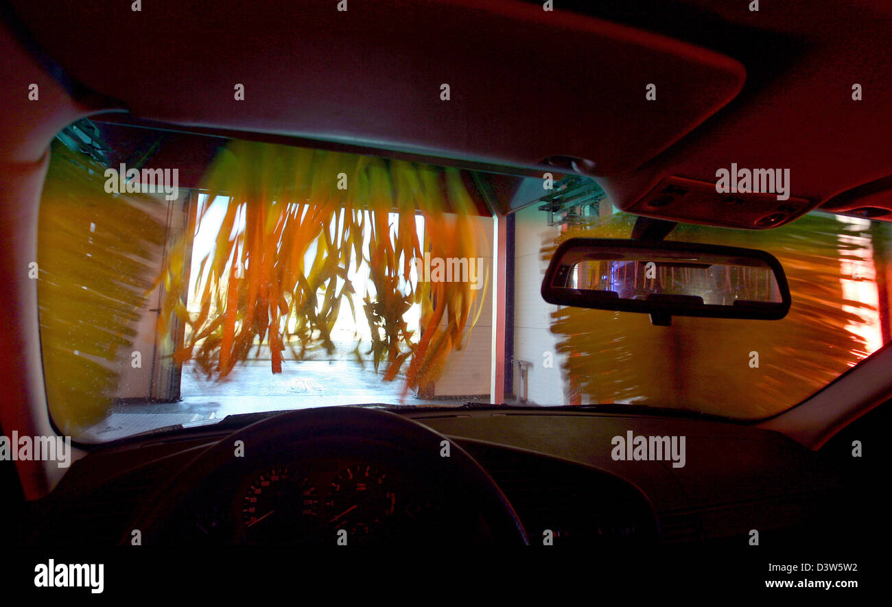 The photo shows the view through the windscreen of a car in a car wash ...