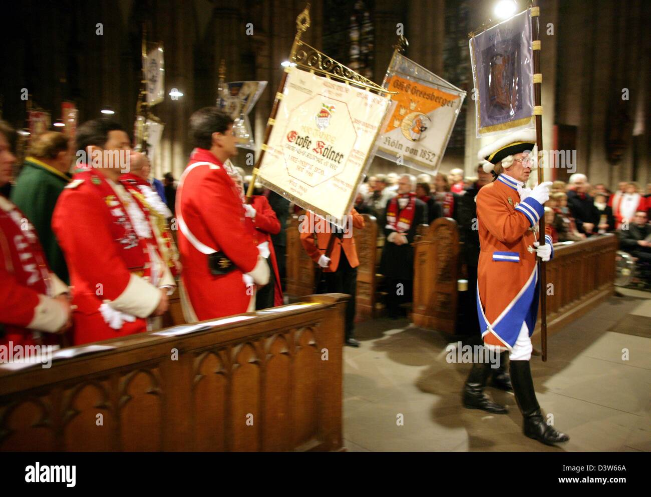 Members of carnival clubs carry flags to the altar during a mass at the ...