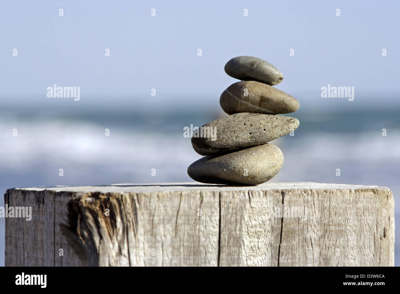 The photo shows several pebbles balancing on top of each other on an ...