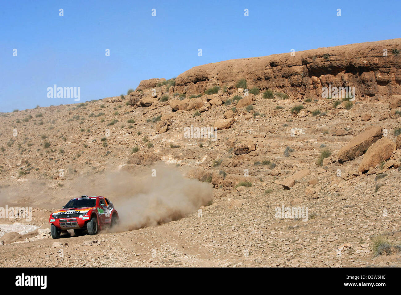 French rallye pilot Luc Alphand paces his Mitsubishi Pahero through the ...