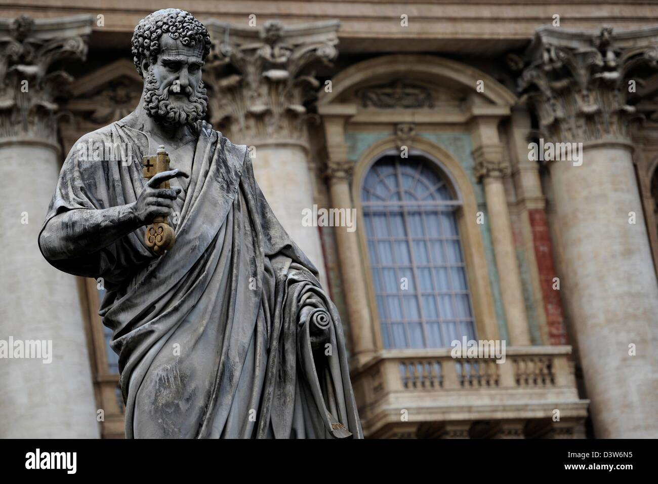 Statue of Saint Peter stands under gray sky on St. Peters Square in ...