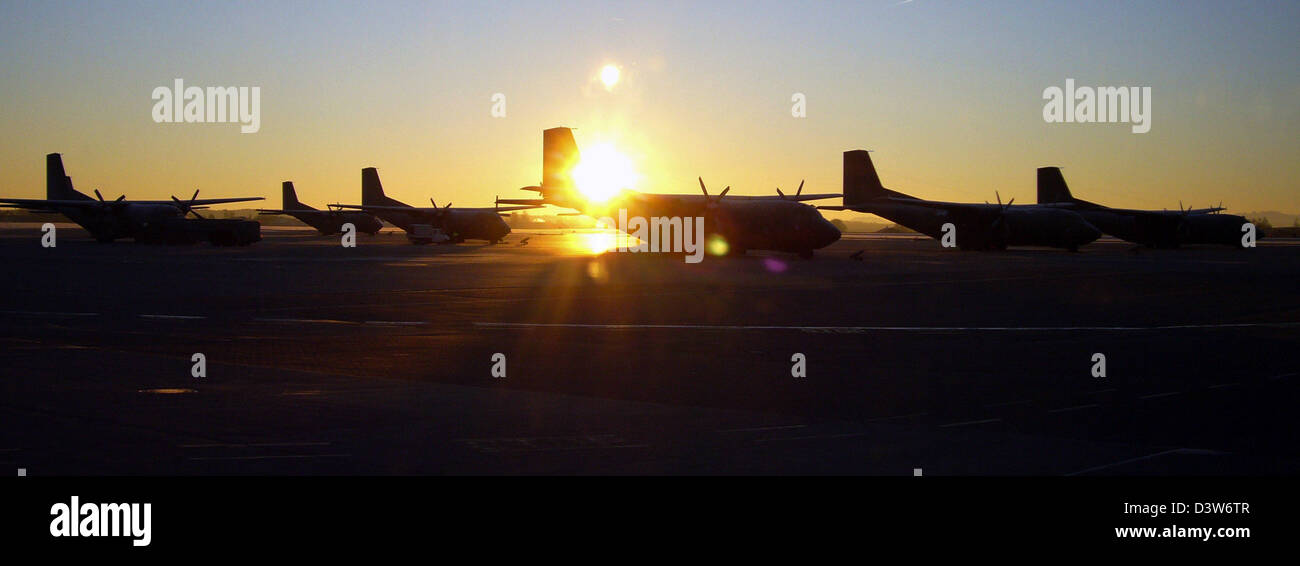 The sun rises behind transport planes of the type 'Transall' at the ...