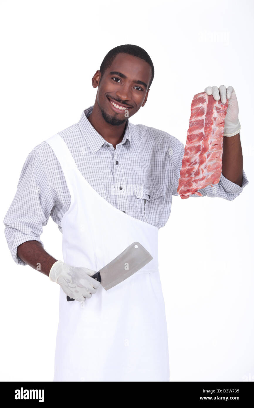 Happy butcher showing meat Stock Photo - Alamy