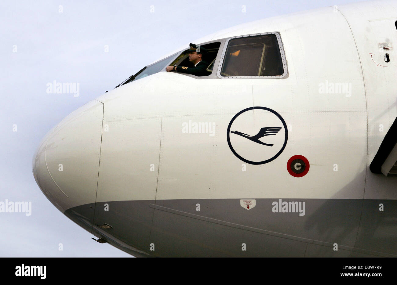 A Lufthansa pilot looks out of the cockpit window of a freight plane of ...