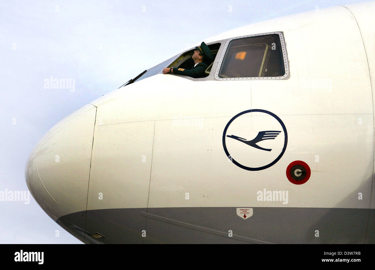 A Lufthansa pilot looks out of the cockpit window of a freight plane of ...
