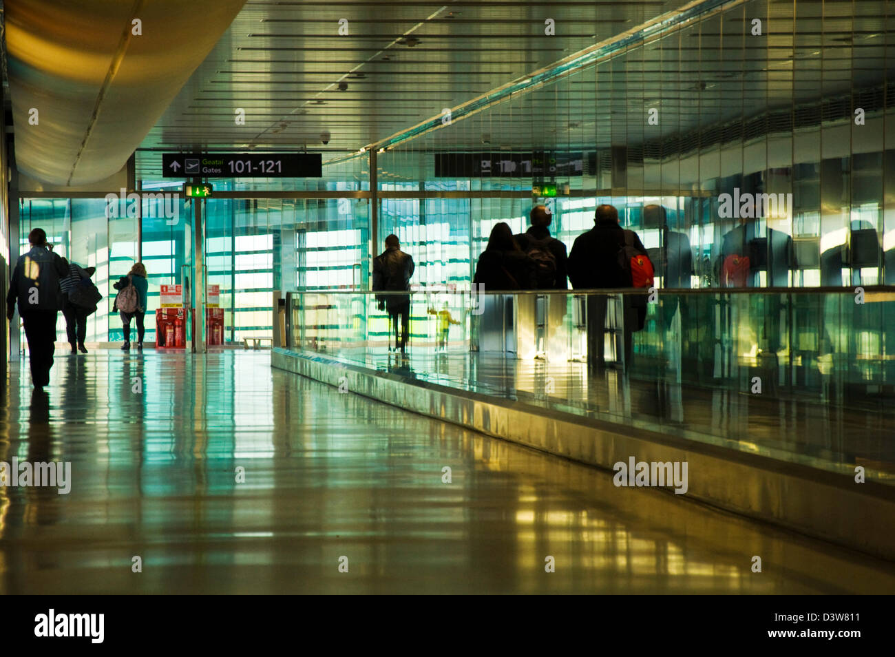Passengers walk along to gate in departures at Dublin airport Stock ...