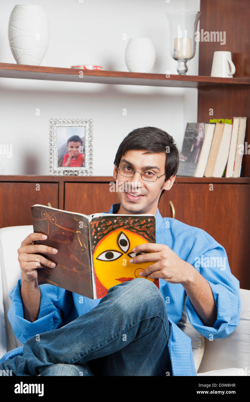 Bengali man reading a magazine Stock Photo - Alamy