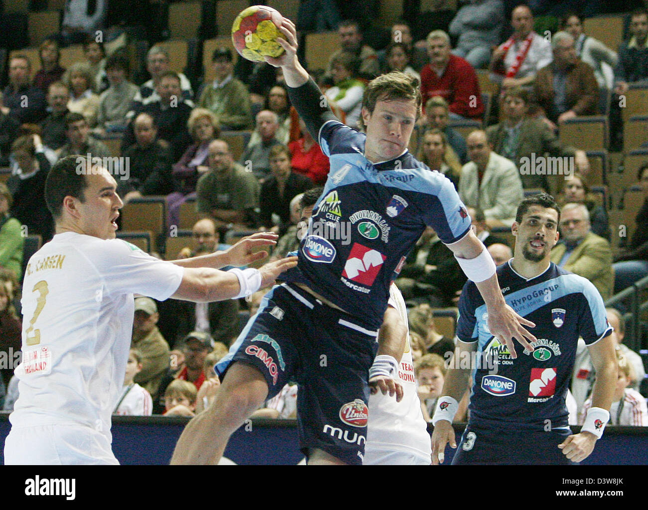 Slovenian player Rok Ivancic (C) struggles for the ball with Rasmus ...