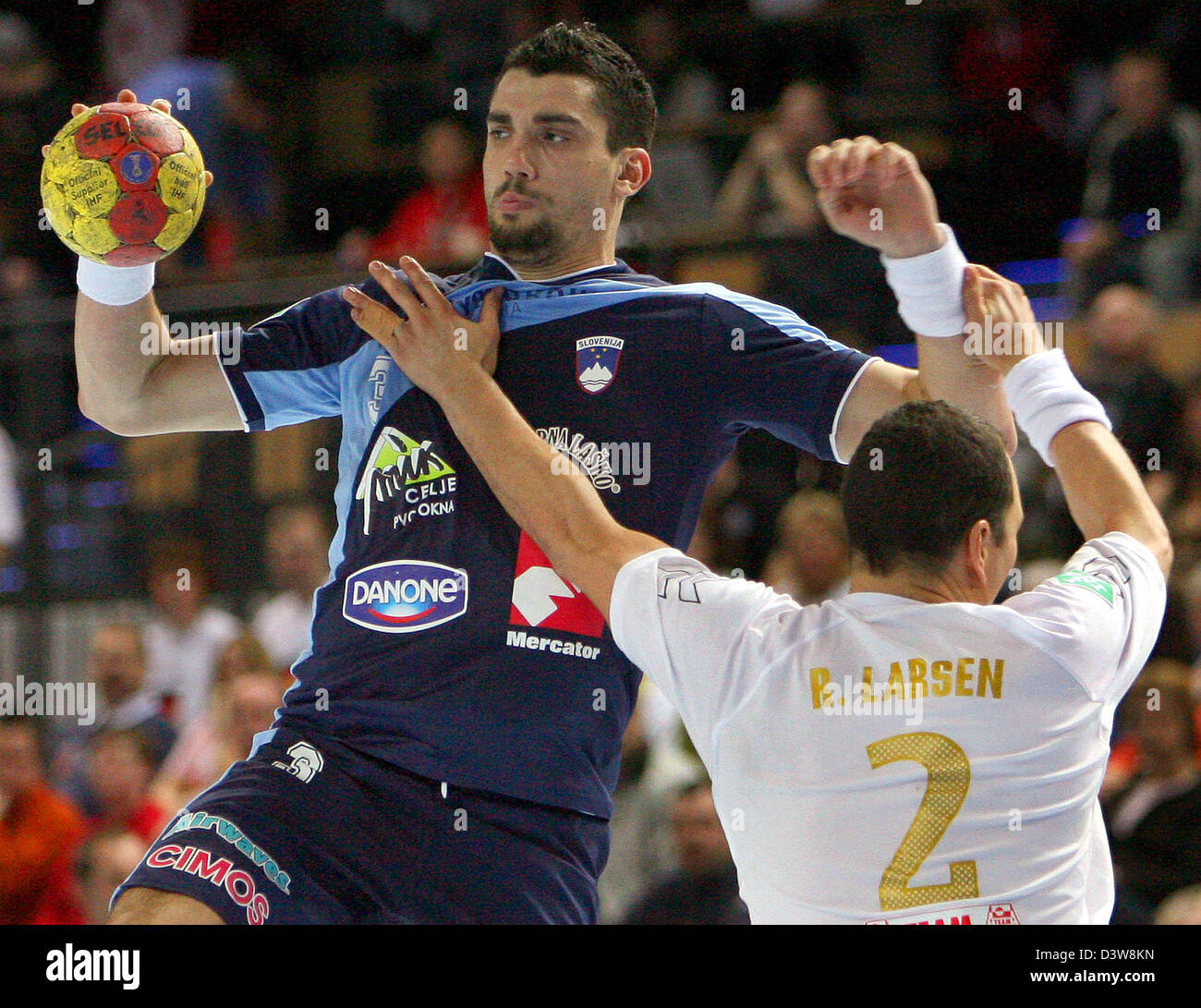 Slovenian player Ognjen Backovic (L) vies for the ball with Rasmus ...