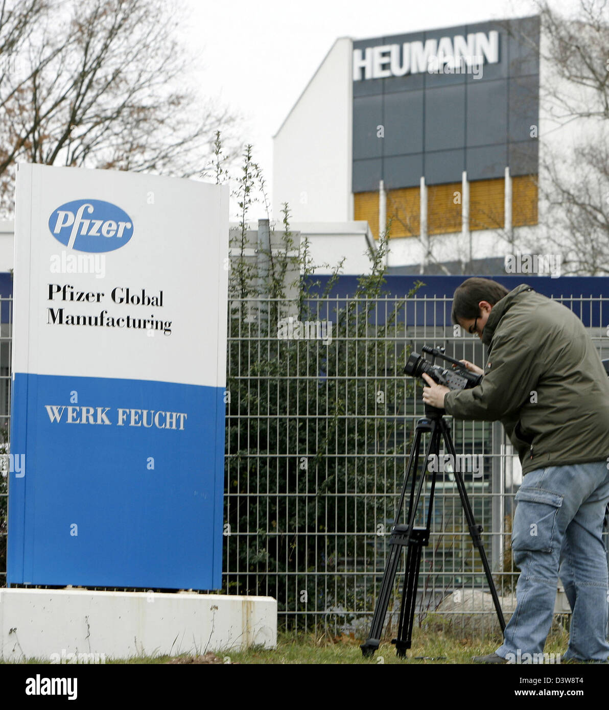 A cameraman films the company entrance and the logo of Heumann PCS, a ...