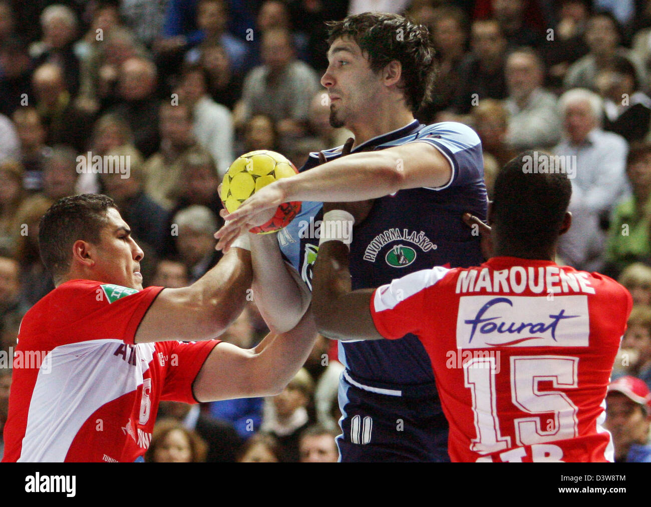 Slovenian handball international David Spiler (C) and Tunesian Issam ...