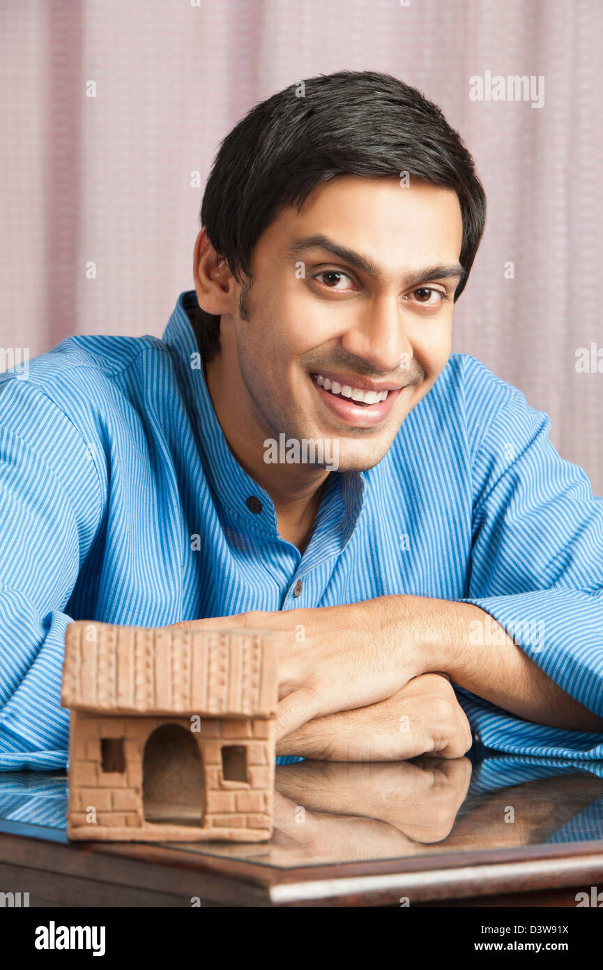 Bengali man with a model home Stock Photo - Alamy