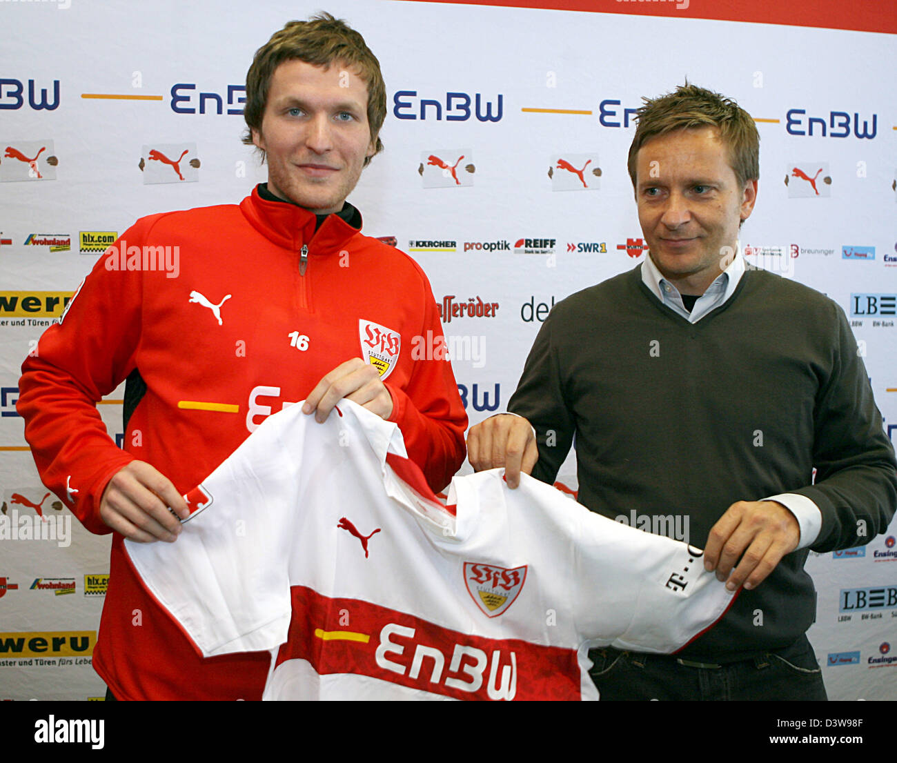 German striker Benjamin Lauth (L) presents his new jersey with German ...