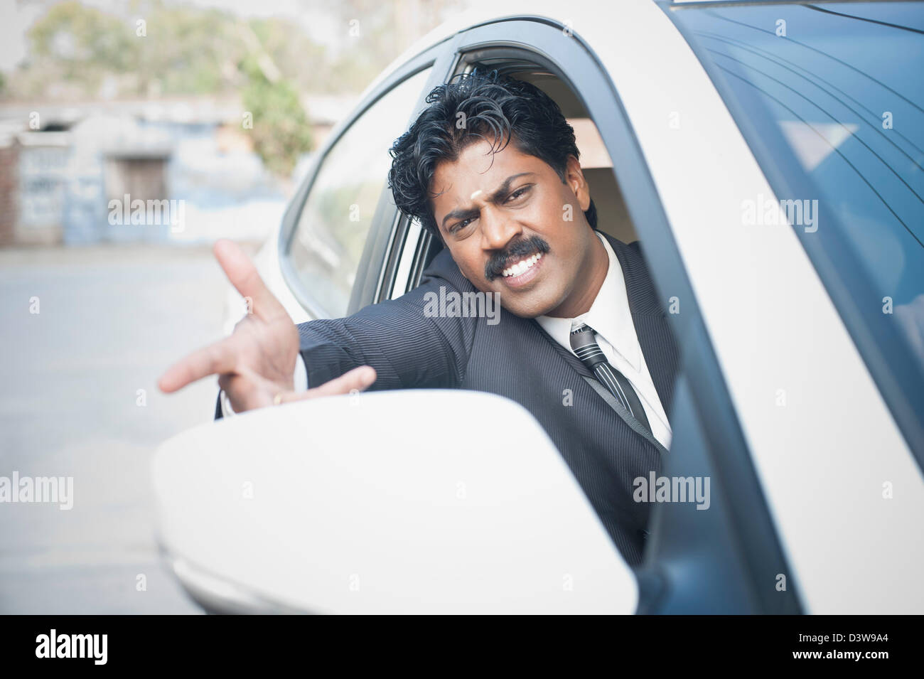 South Indian businessman driving the car and gesturing Stock Photo - Alamy
