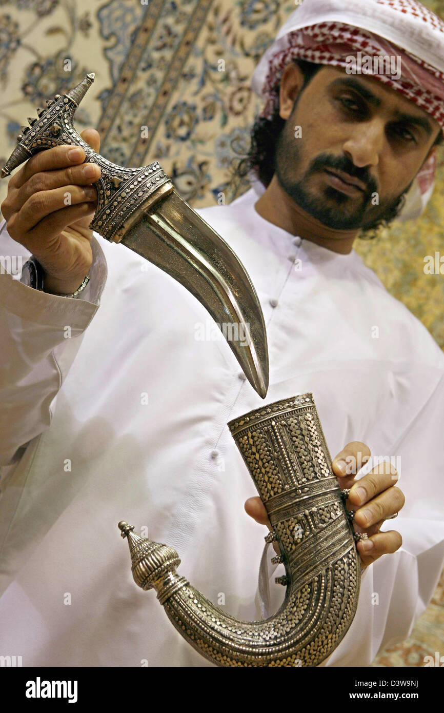An Arab poses with a traditional decorated dagger in a shop at the ...