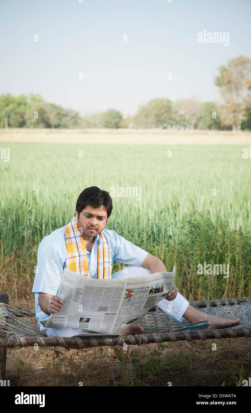 Farmer reading a newspaper in the field, Sohna, Haryana, India Stock Photo - Alamy