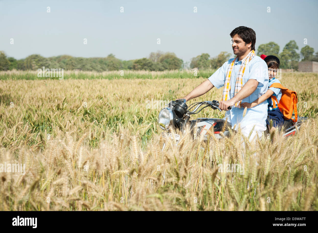 Farmer with his daughter riding a motorcycle in the field, Sohna, Haryana, India Stock Photo - Alamy