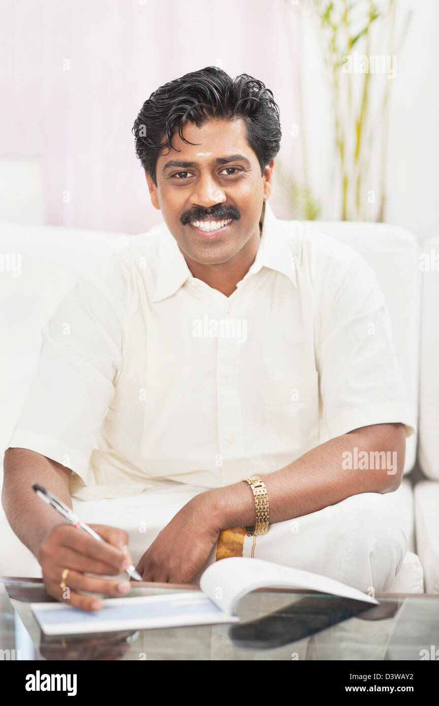 Indian asian man signing hi-res stock photography and images - Alamy