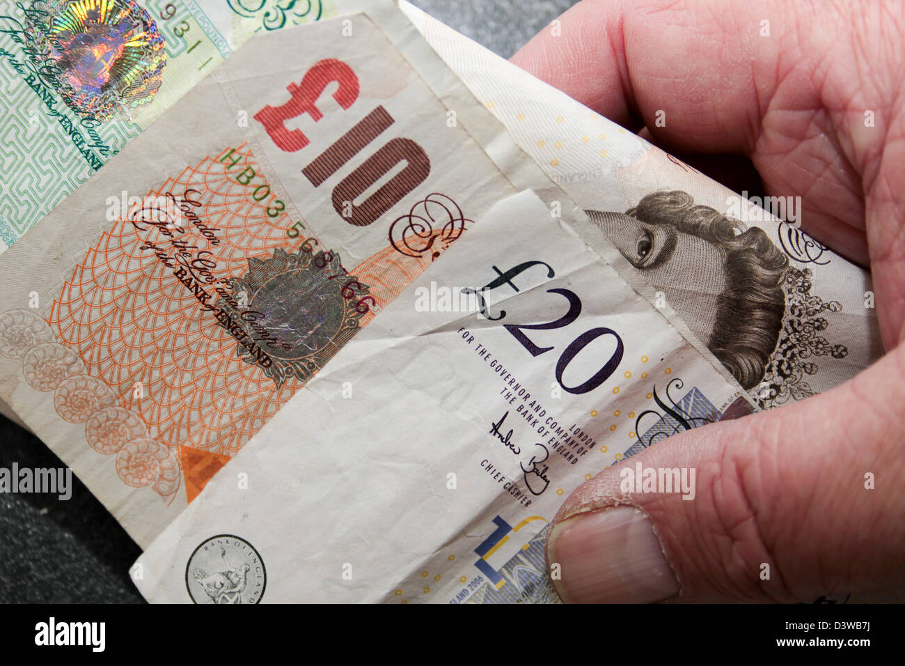 20 pound notes and hand hi-res stock photography and images - Alamy