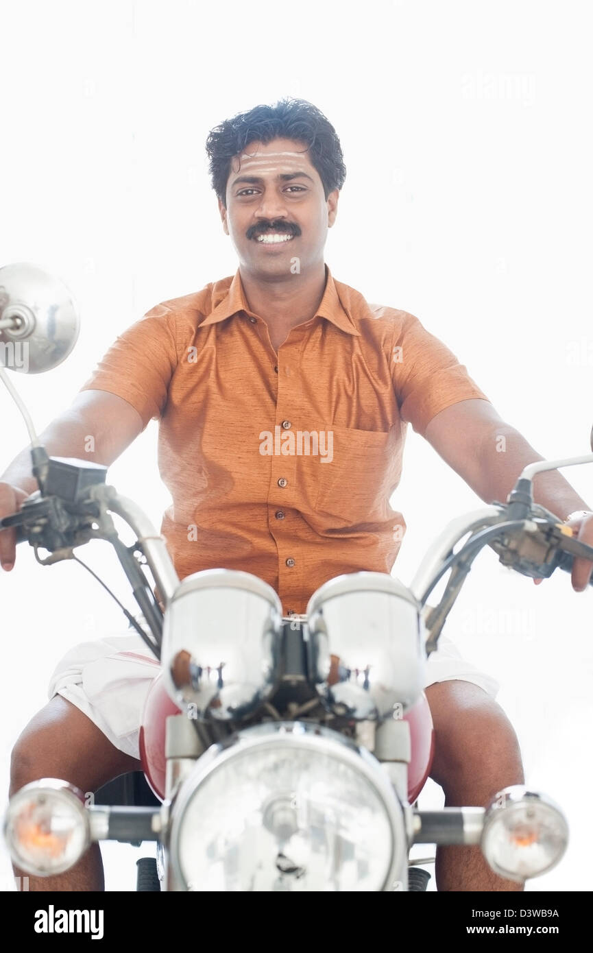 South Indian man riding a motorcycle Stock Photo - Alamy
