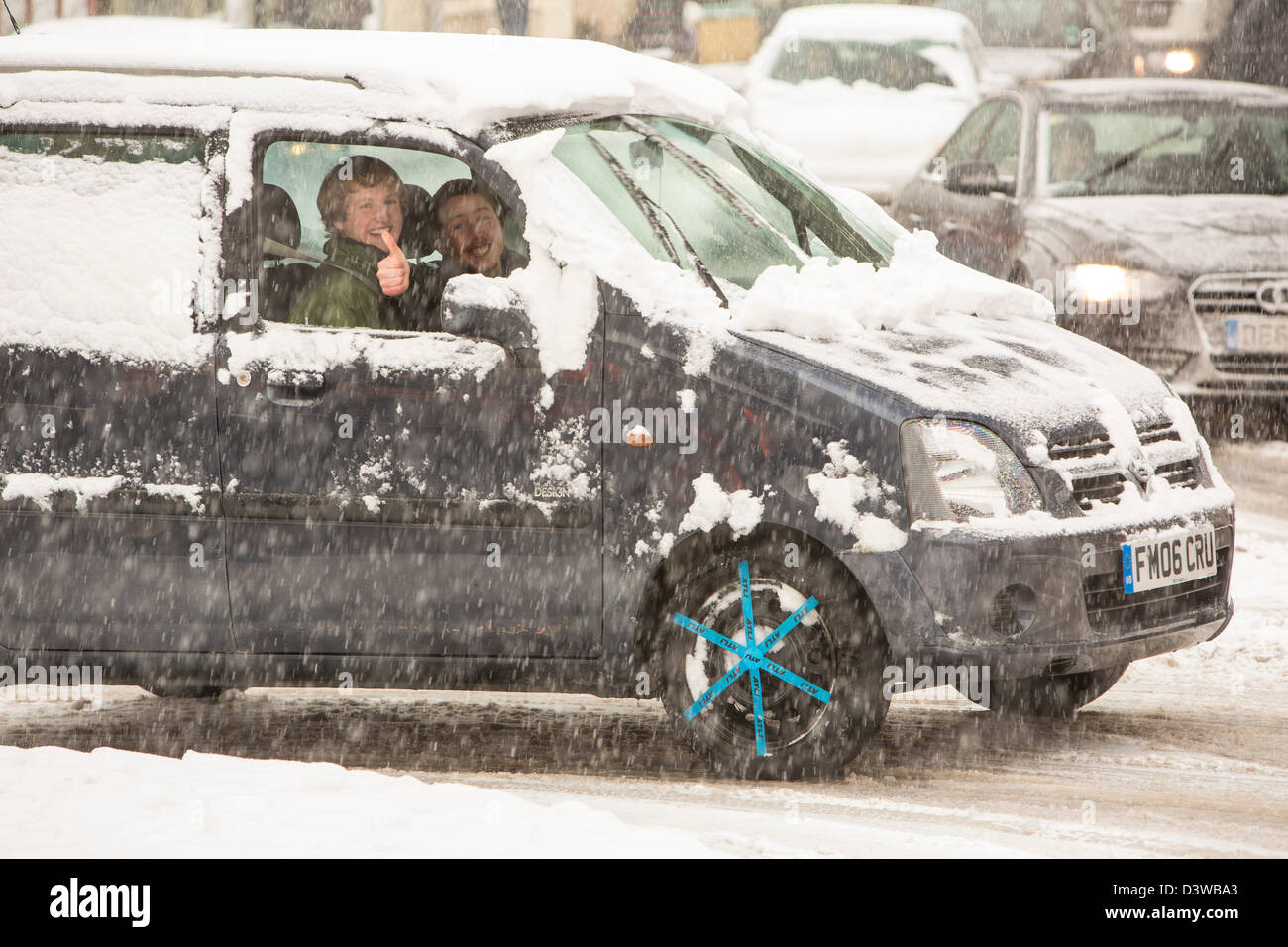 Cars driving through heavy snow in Ambleside, Lake District, UK Stock ...