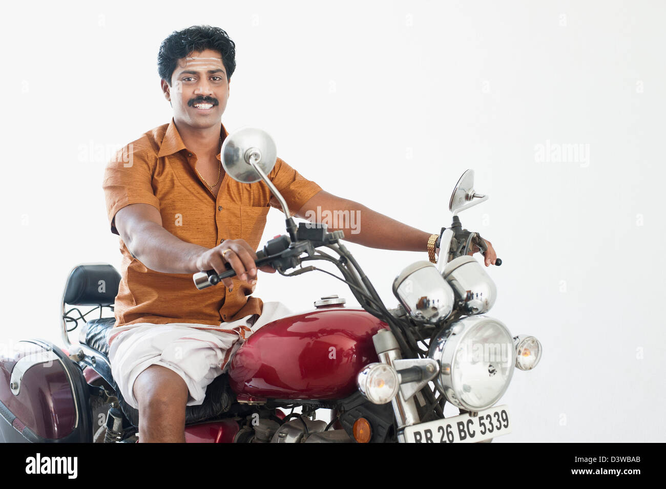 South Indian man riding a motorcycle Stock Photo - Alamy