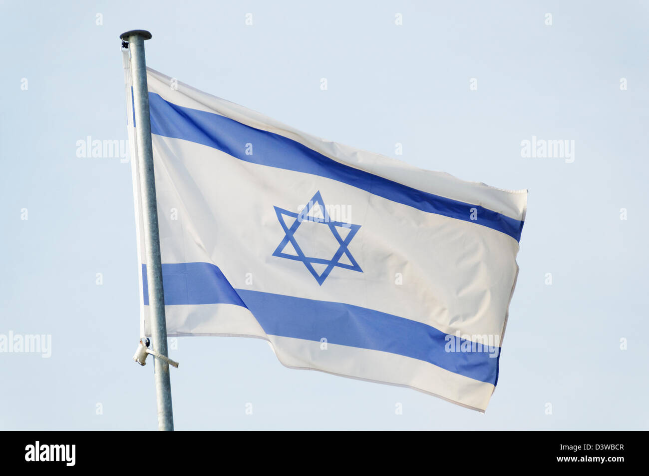 Israeli flag on a mast, sky background Stock Photo - Alamy