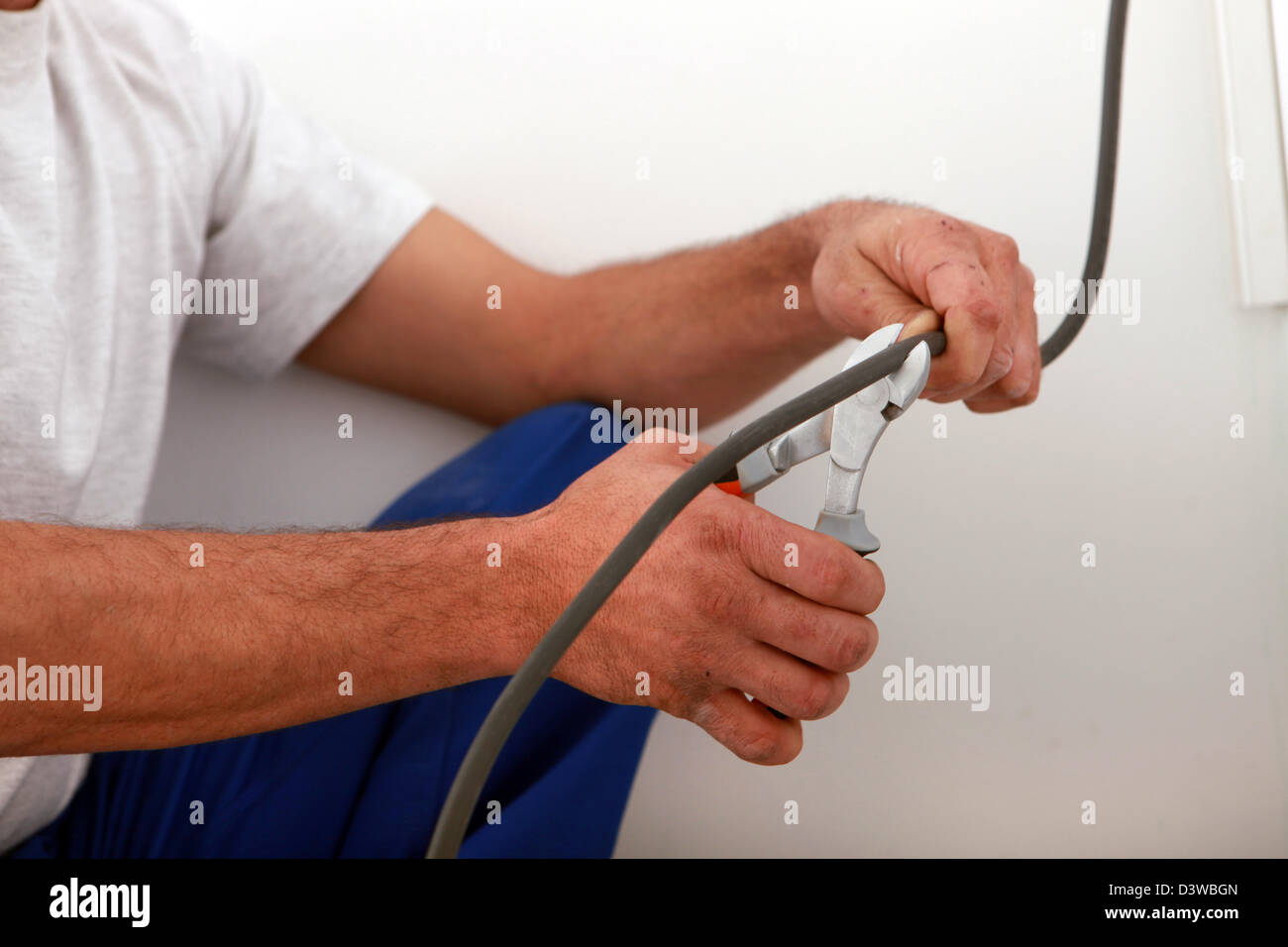Electrician cutting cable Stock Photo - Alamy