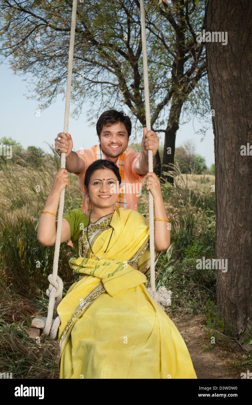 Farmer pushing his wife on a swing in the field, Sohna, Haryana, India Stock Photo - Alamy
