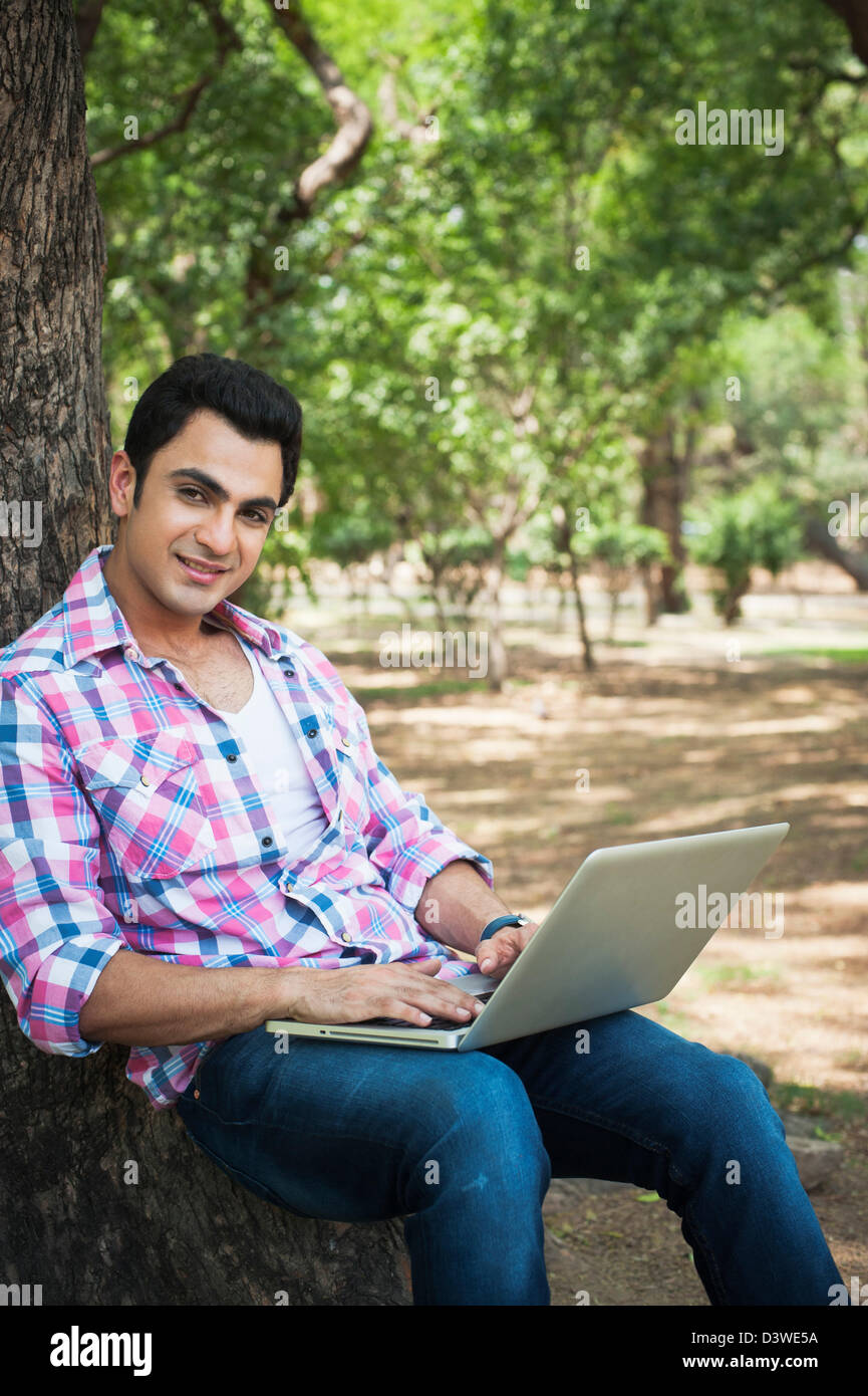 Man using a laptop in a park, Lodi Gardens, New Delhi, Delhi, India ...