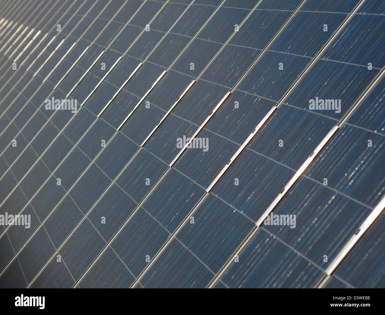 A series of large solar panels forms a symmetrical line at a power ...