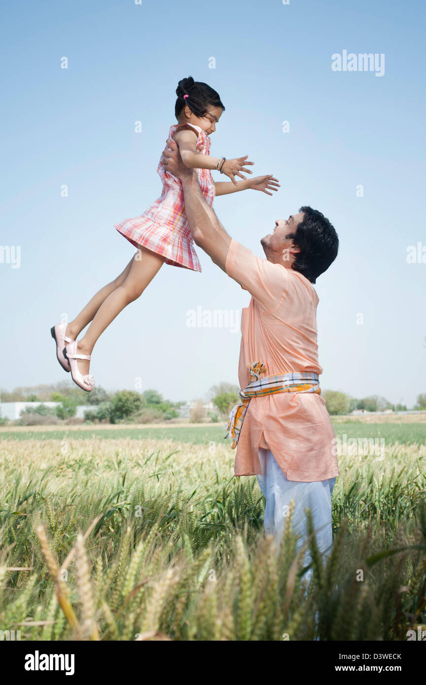 Farmer carrying his daughter in the field, Sohna, Haryana, India Stock Photo - Alamy