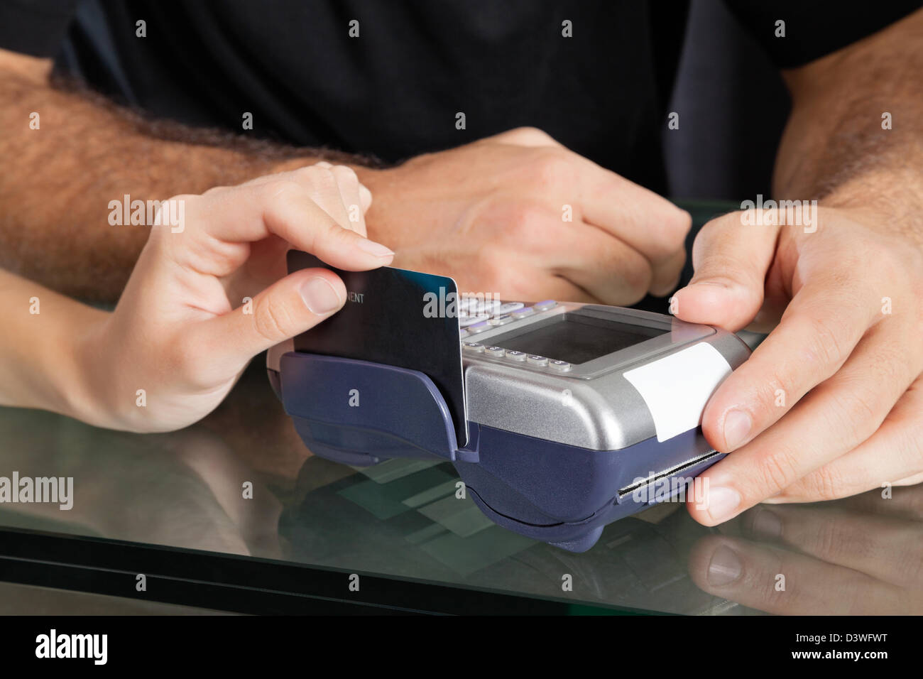 Hand Swiping Credit Card Through Terminal At Salon Stock Photo - Alamy