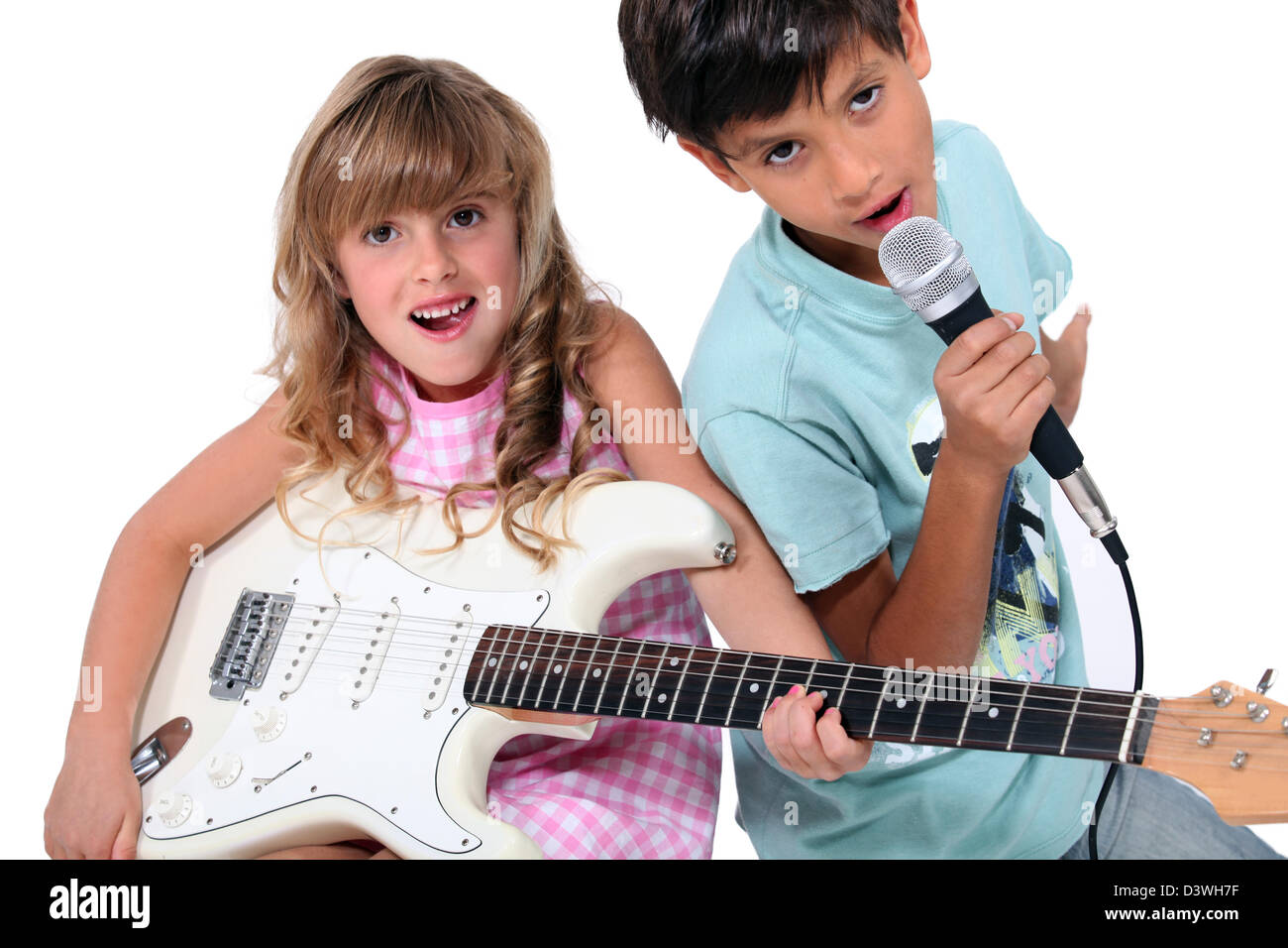 Little boy and girl playing musical instruments Stock Photo - Alamy