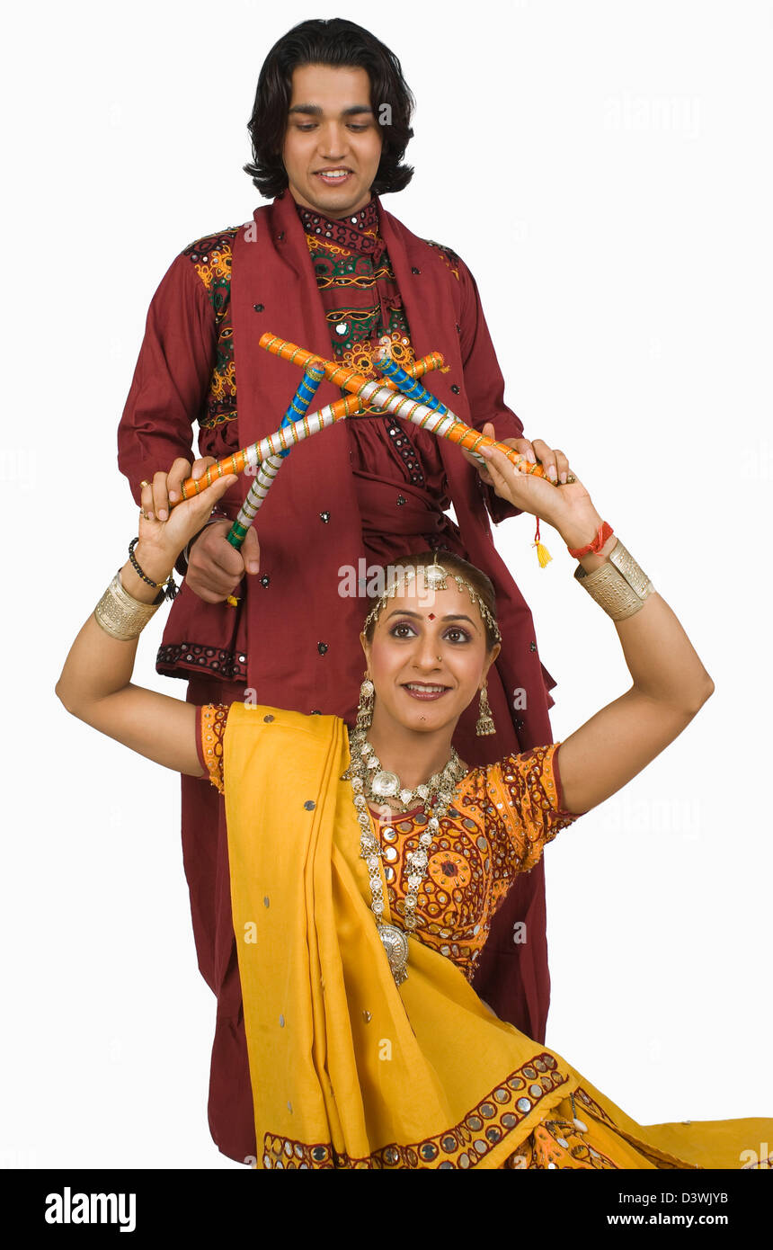 Couple performing dandiya Stock Photo - Alamy