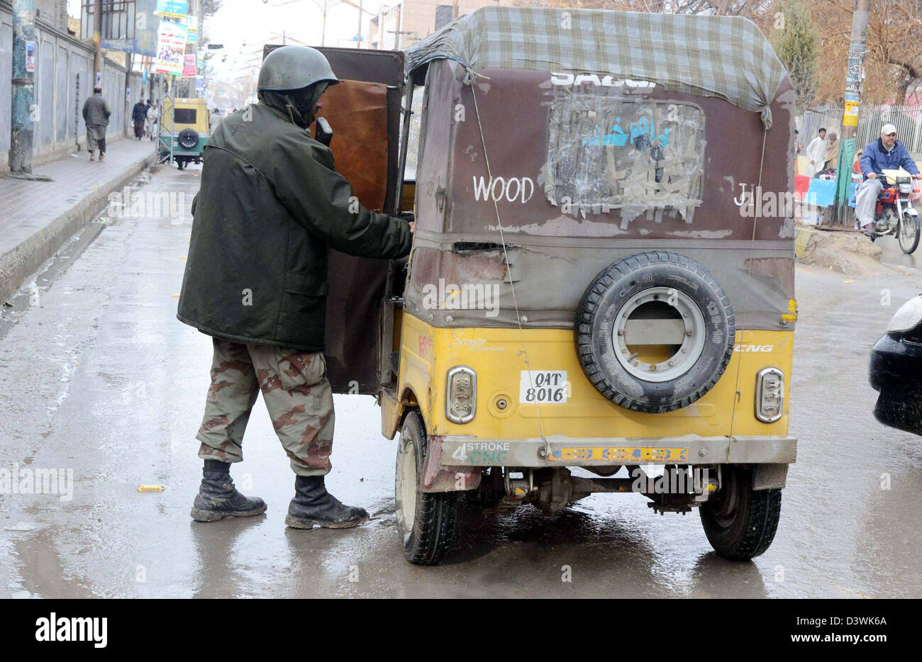 Frontier Constabulary (FC) official search a rickshaw during snap ...