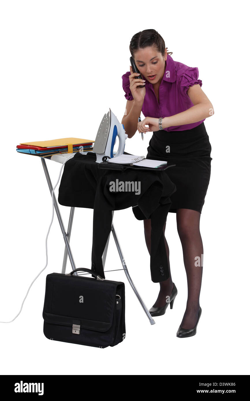 Late businesswoman ironing a suit jacket Stock Photo - Alamy