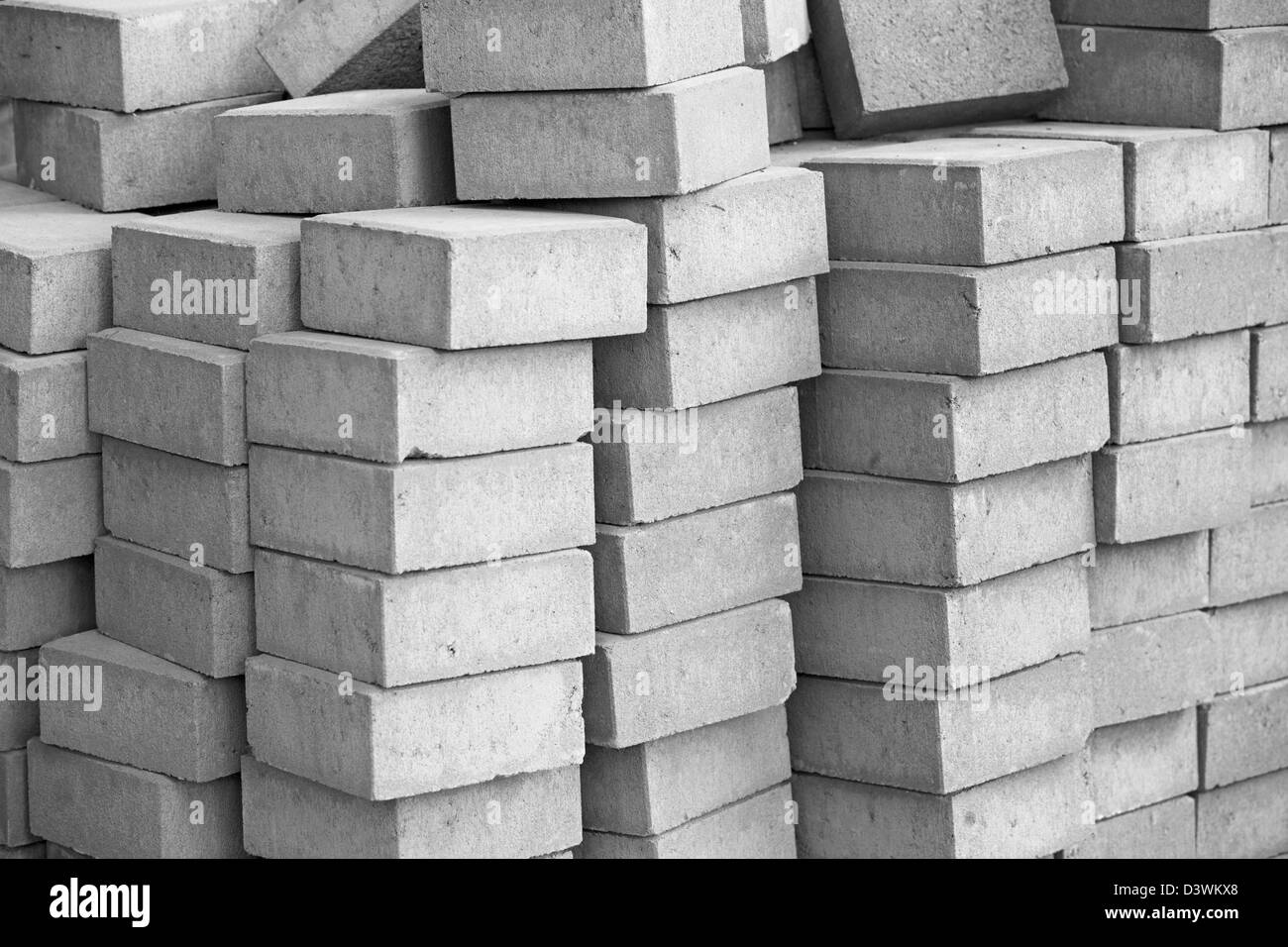 Silicate grey bricks cobblestone in stacks for paving Stock Photo - Alamy